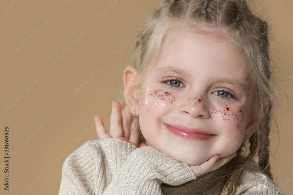 Portrait of cute little blonde girl with boxer braids and glitters om ...