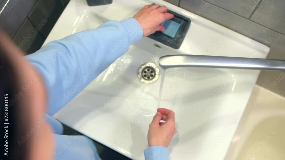 Top View. washing and toweling hands with soap and water in bathroom ...