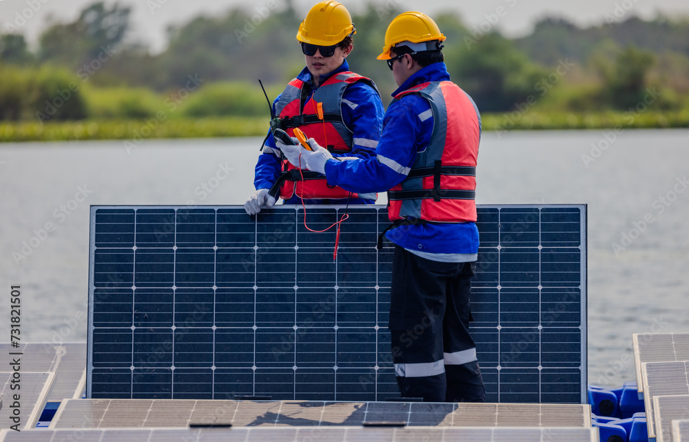 Technicians check floating solar farm wiring, polarity, and grounding ...