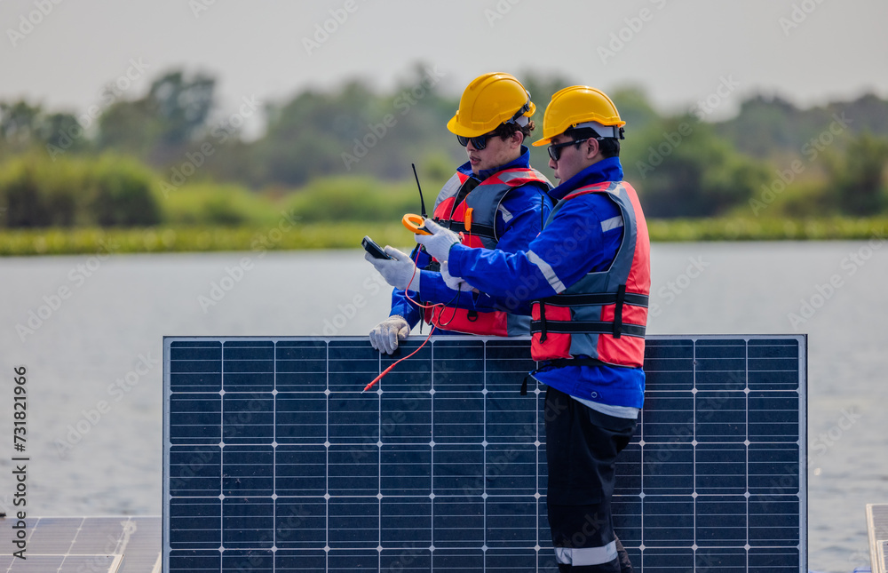Technicians check floating solar farm wiring, polarity, and grounding ...