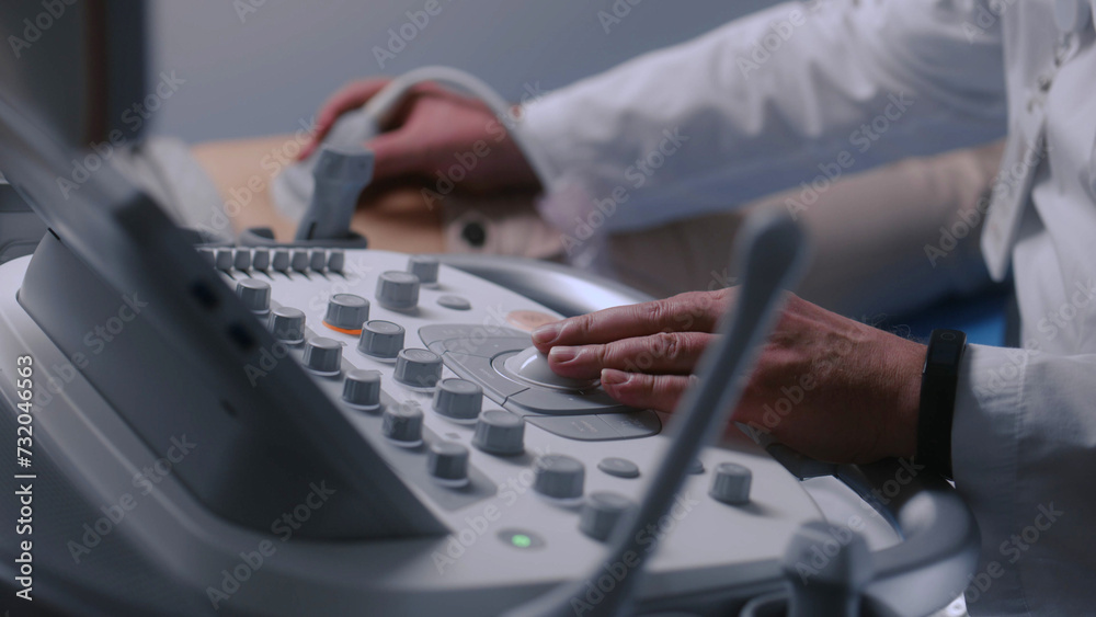 Doctor uses sonography machine with monitor. Medical specialist ...