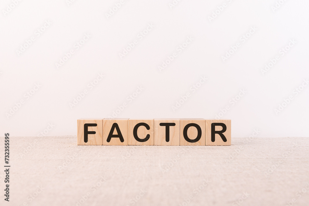 factor - word made from wooden blocks with letters, extremely ...