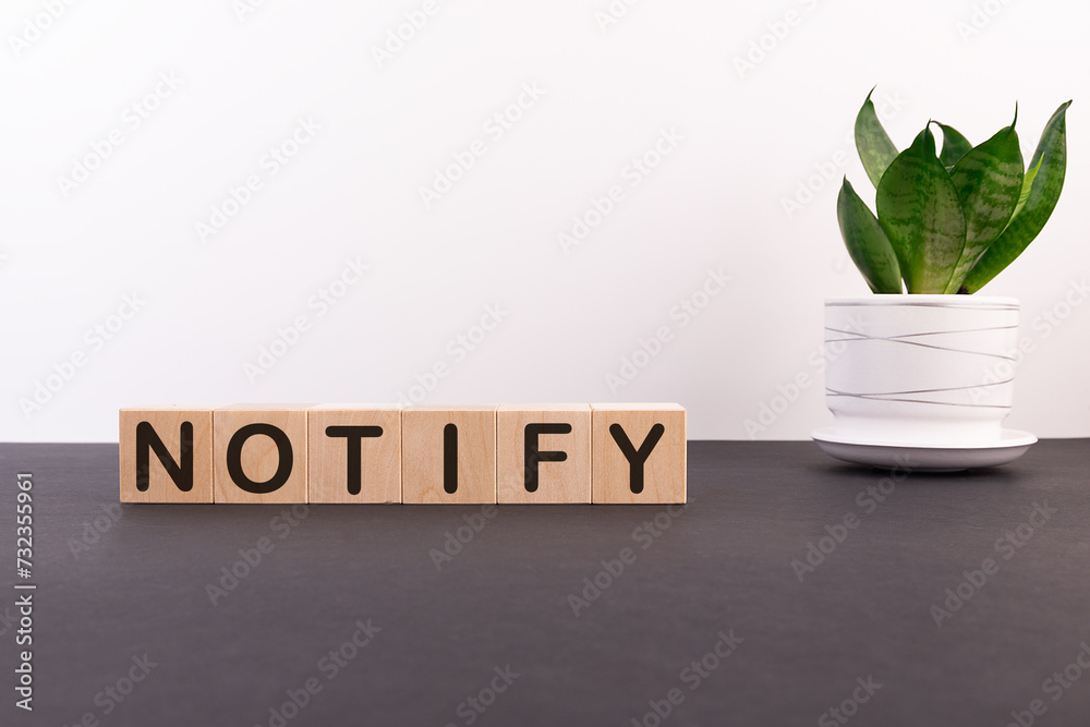 The word NOTIFICATIONS made of building blocks on a dark table with a ...