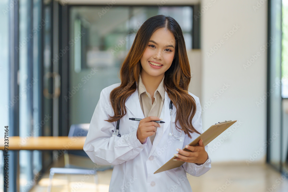 Asian cheerful happy young female professional successful doctor ...