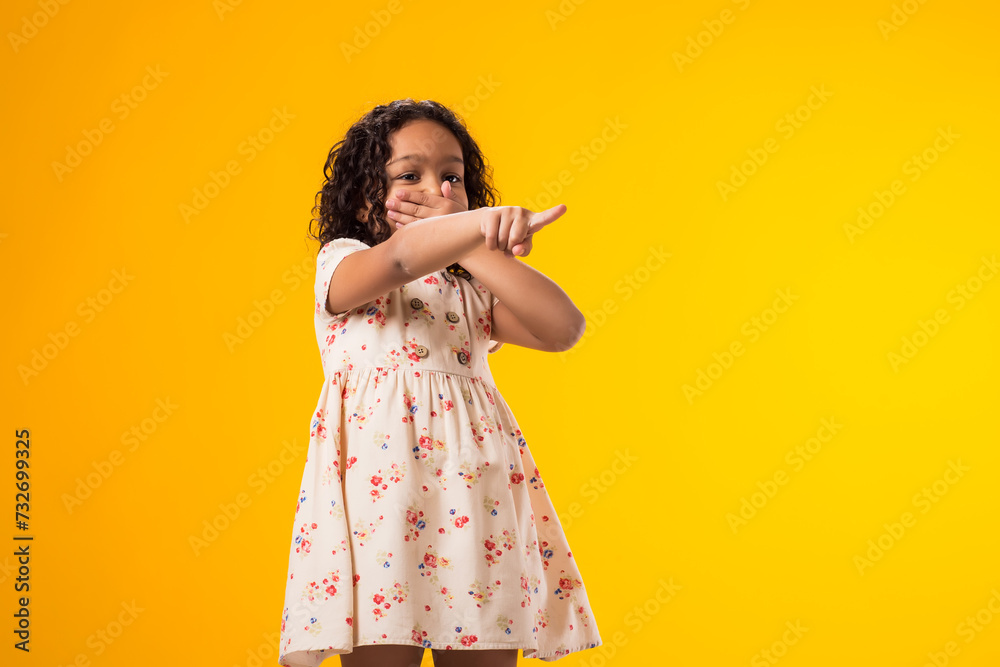 Kid girl mocking and teasing at someone showing finger at camera and ...