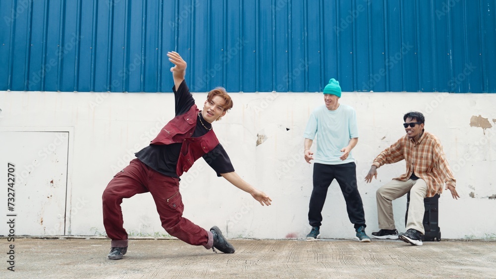 Young street dancer dancing in hip hop style with multicultural friends ...