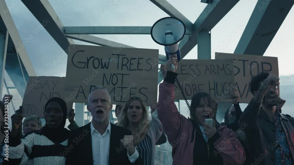 Serious diverse group of people demonstrating against the war and ...
