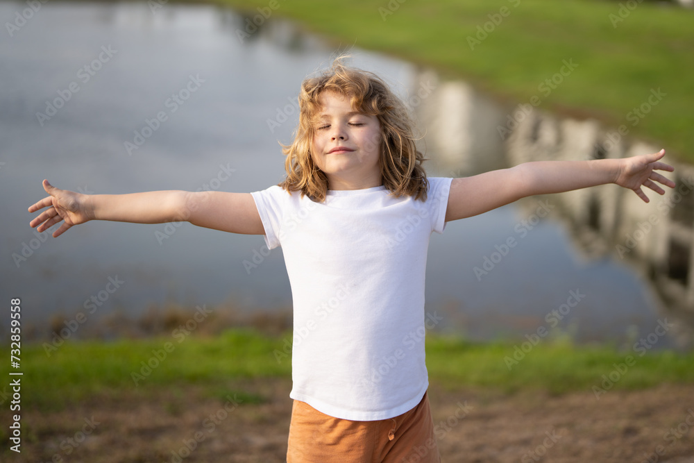 Kid with arms up enjoying freedom in nature. Child open arms enjoying ...