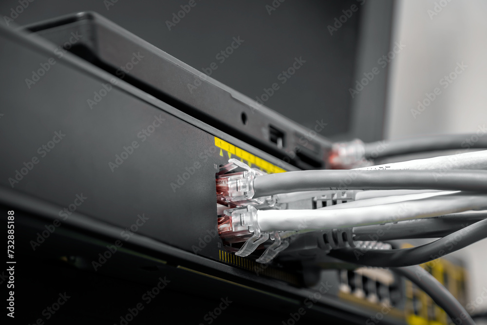 Network Gigabit Smart PoE Switch with connected network cables getting ...