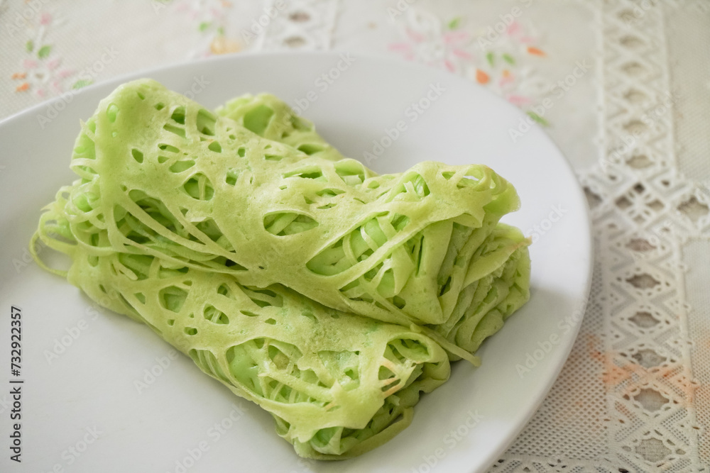 Roti jala is a typical Malay food in North Sumatra and served with ...