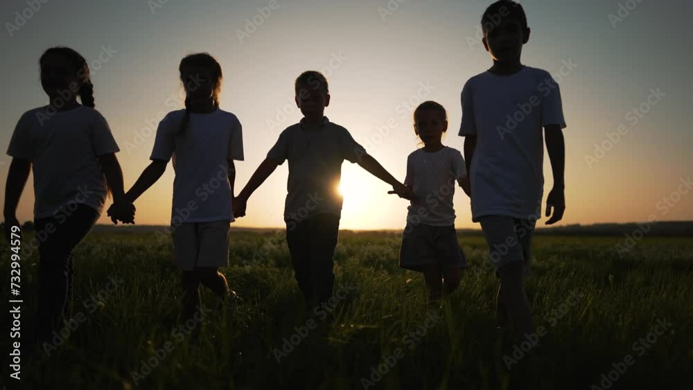 Teamwork concept.family in nature at sunset holding hands and walking ...