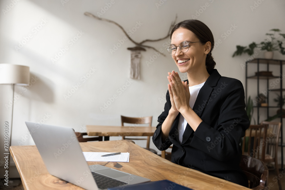 Happy young project manager celebrating professional success at laptop ...