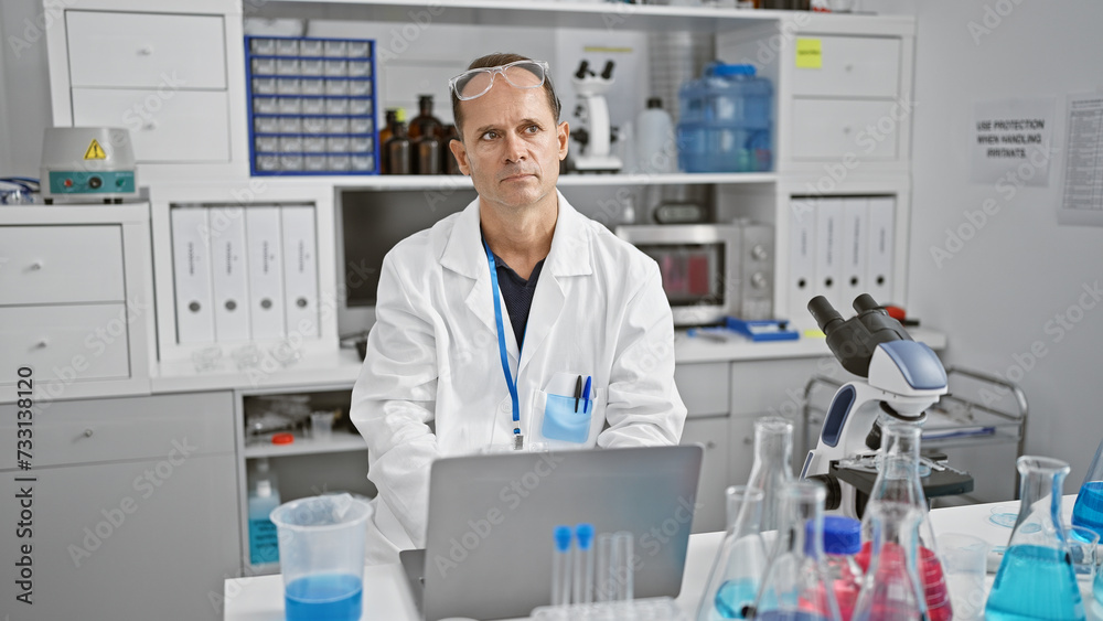 Serious, middle age man-scientist, immersed in his thoughts, consumed ...