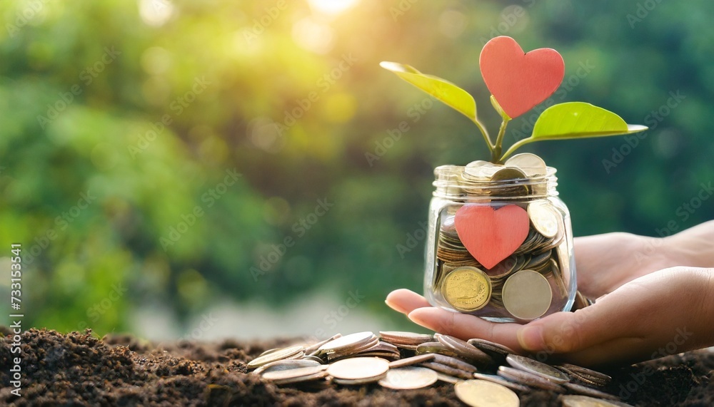 hand holding a jar of heart tree growing on money coins charity social ...