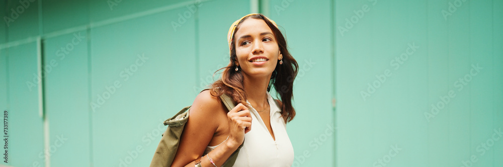 Beautiful girl with tanned skin, brown long hair wearing wireless ...