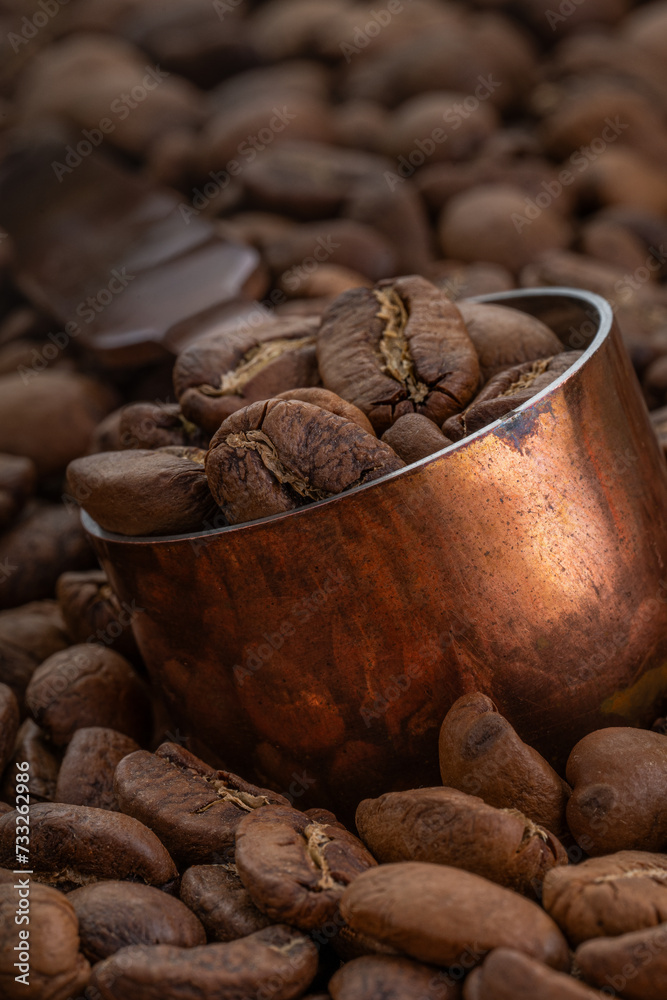 Hand-roasted Arabica Maragogipe coffee beans in a copper measuring ...