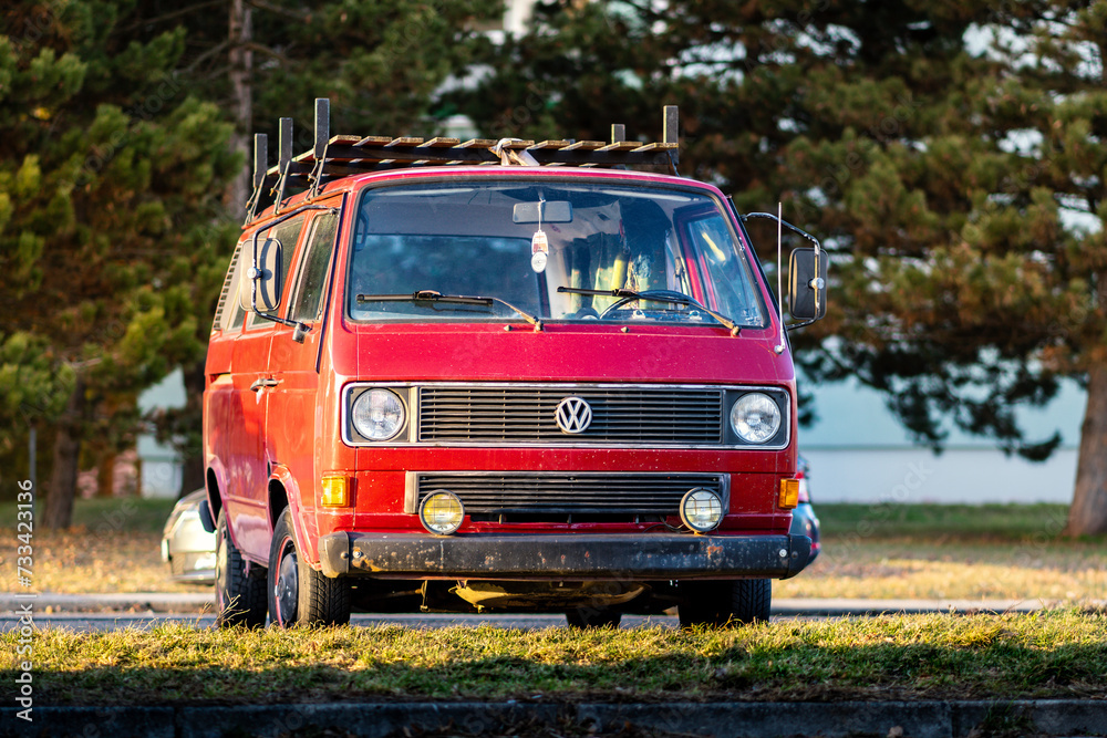 Red old classic minivan Volkswagen Transporter T3 from the 80s stands ...