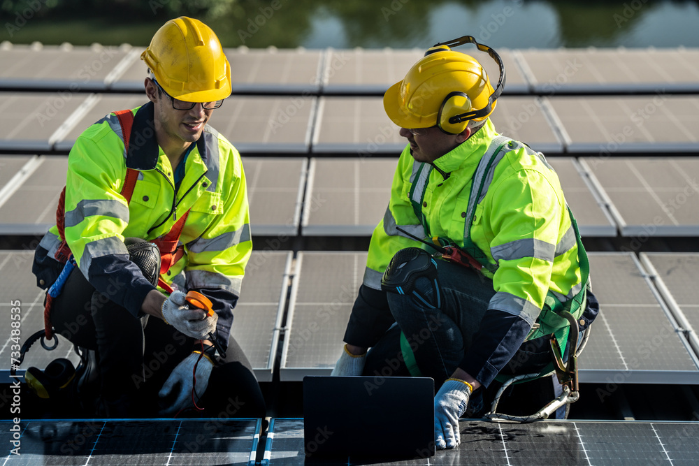 Worker Technicians are working to construct solar panels system on roof ...