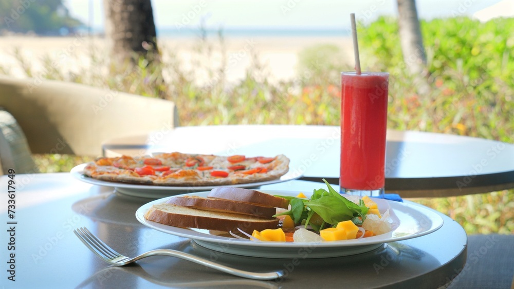 Beachside dining setup with refreshing fruit cocktail and delectable ...