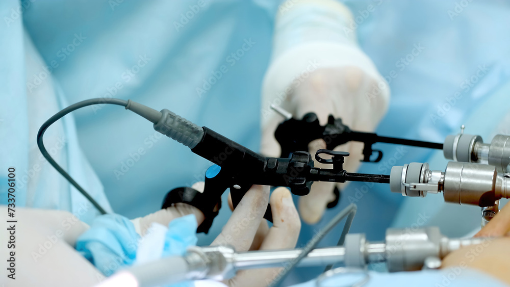 Operating room, team of surgeons performing laparoscopic intervention ...