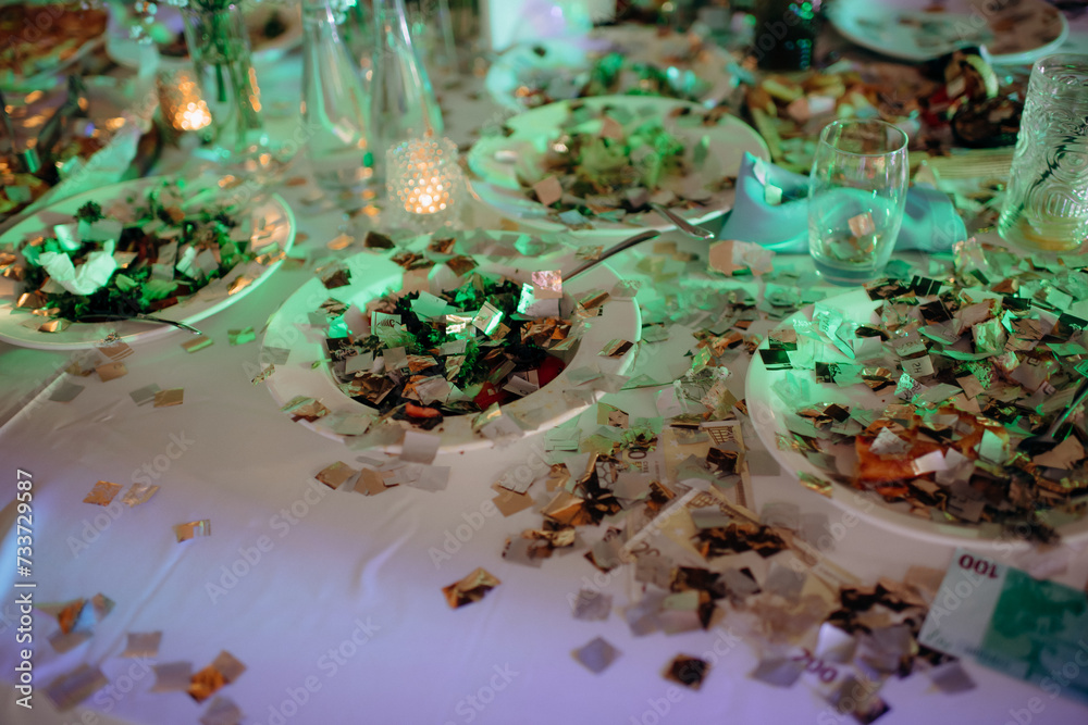 Fotografia do Stock: Sparkling confetti scattered everywhere on tables ...