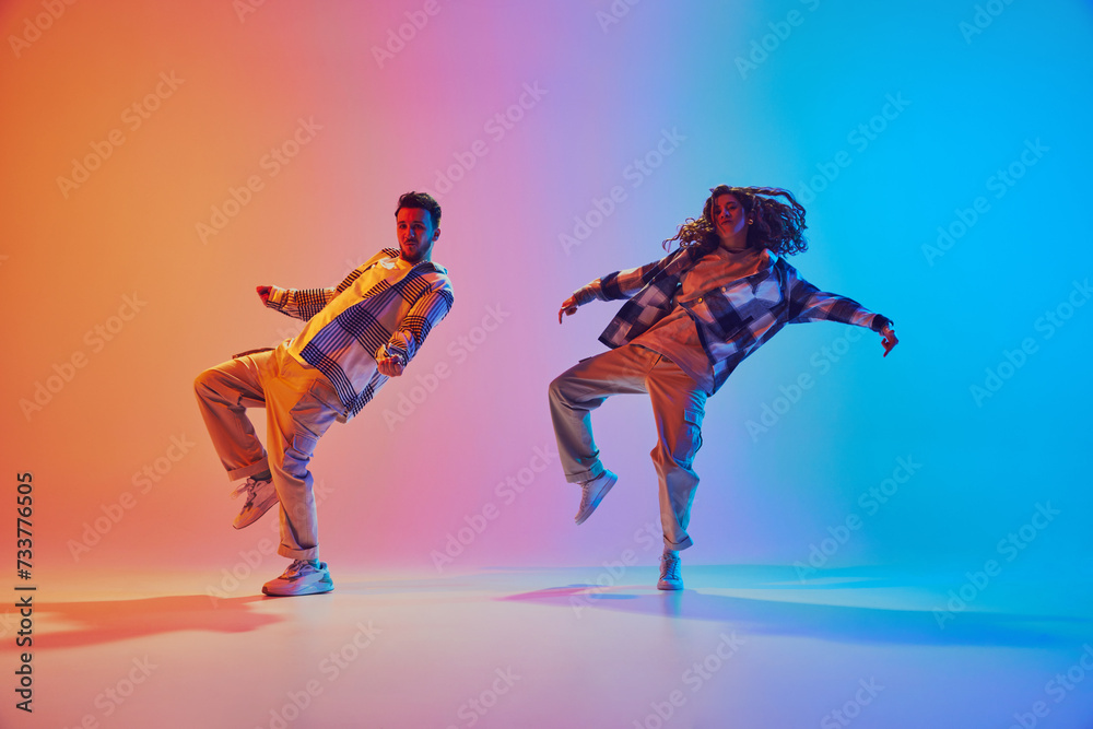 Dynamic photo of two dancers, man and woman move synchronously in hip ...