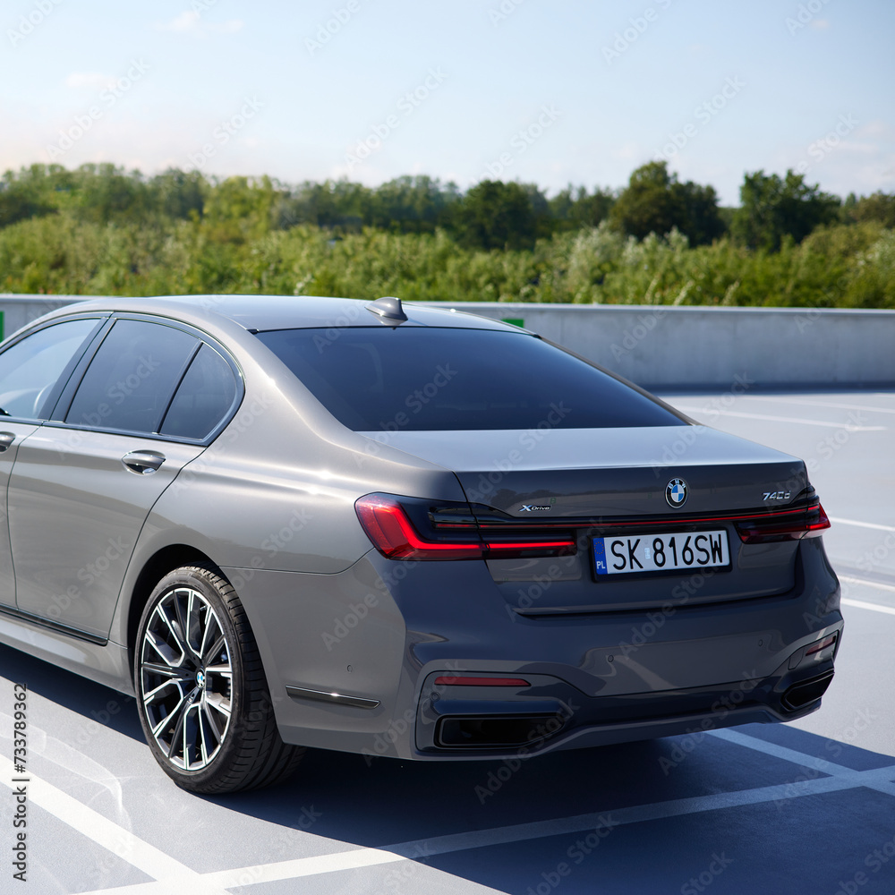 Luxurious gray BMW 740D, model G12. Rear view of the car. Parked in an ...