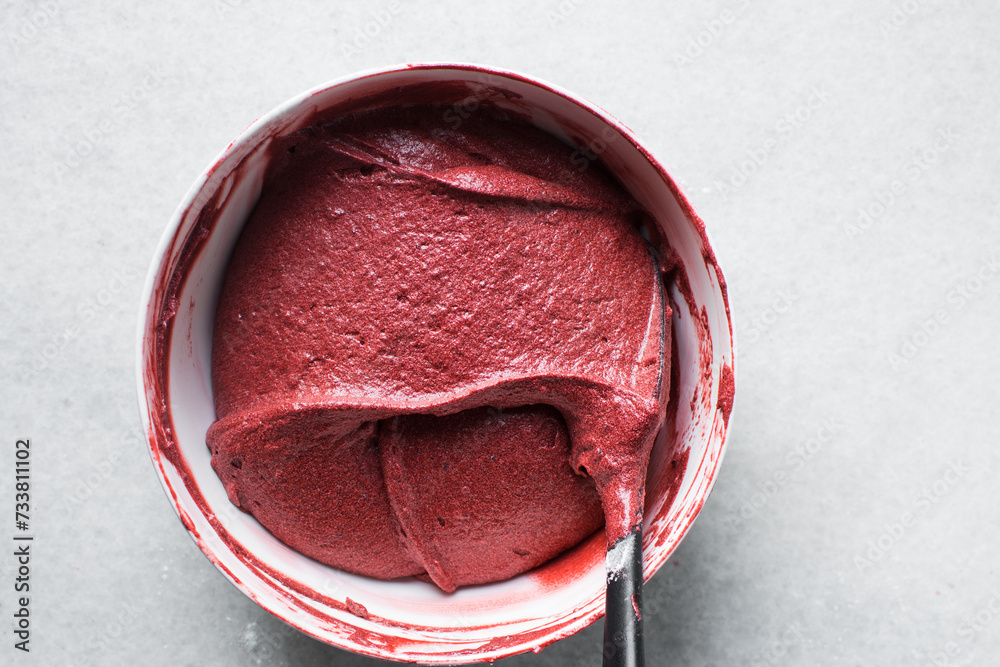Red velvet cake batter in white ceramic mixing bowl, process of making ...