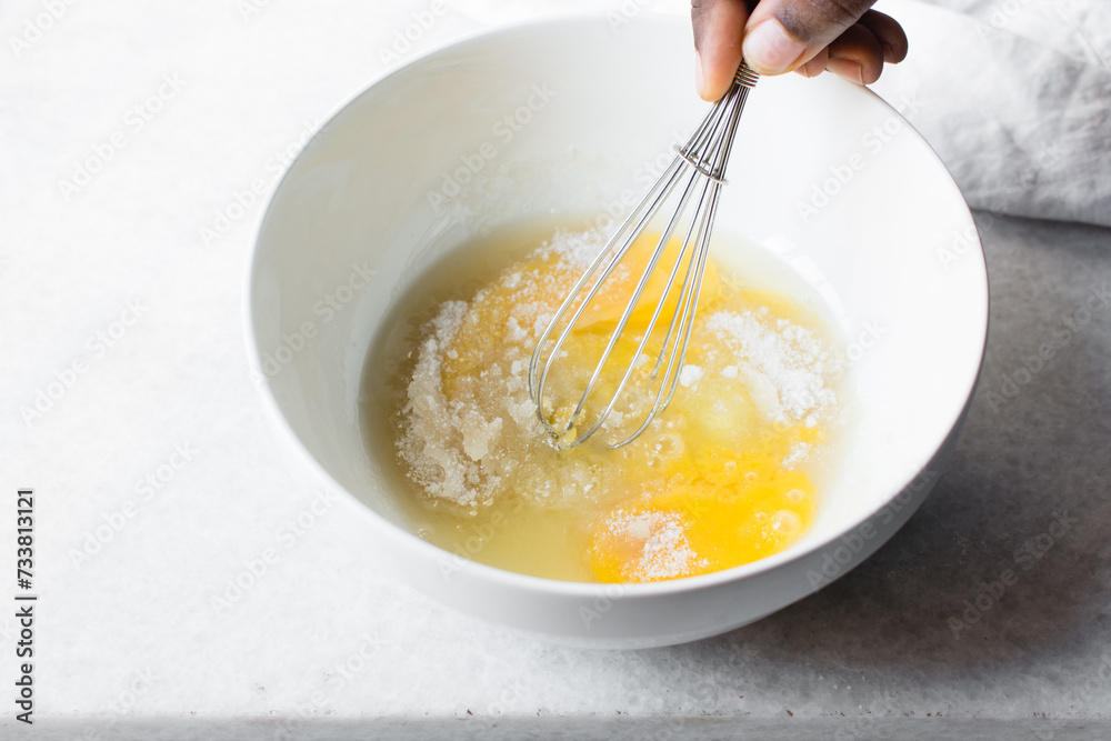 Whisking eggs and sugar together until pale, mixing eggs and sugar by ...
