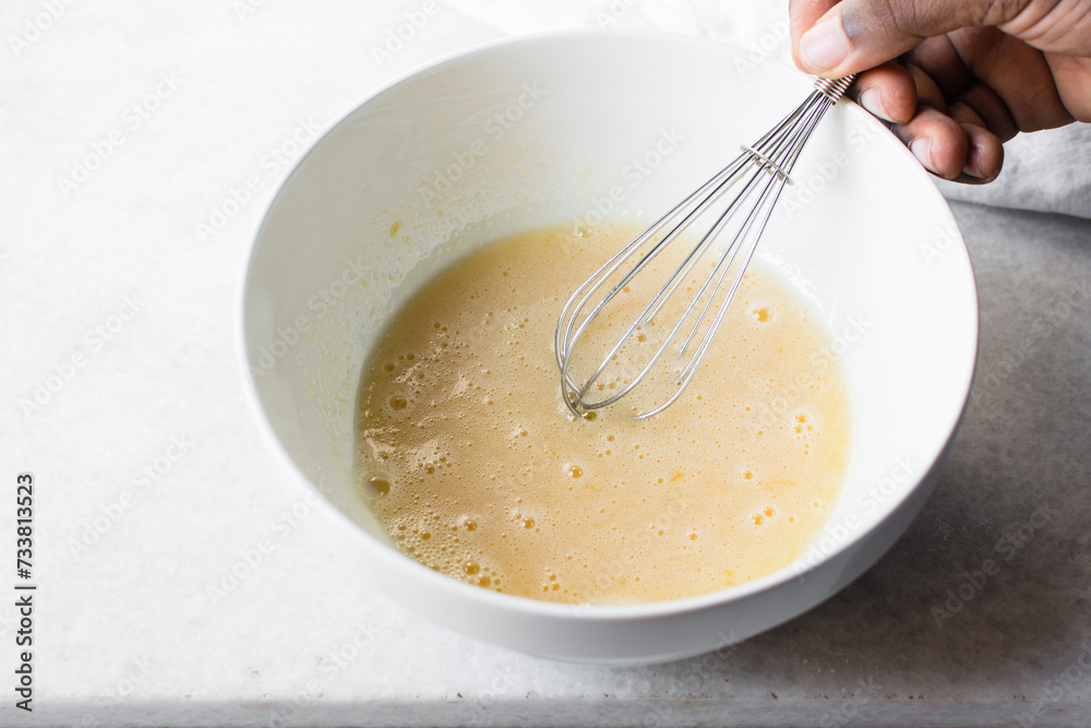 Whisking eggs and sugar together until pale, mixing eggs and sugar by ...