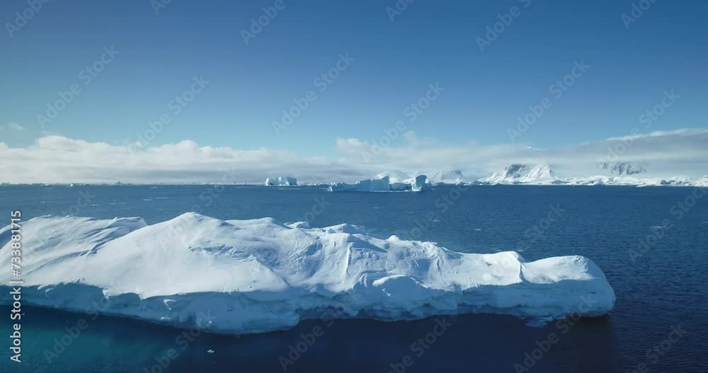 Huge melted glacier drifting blue ocean in Antarctica. Aerial drone ...
