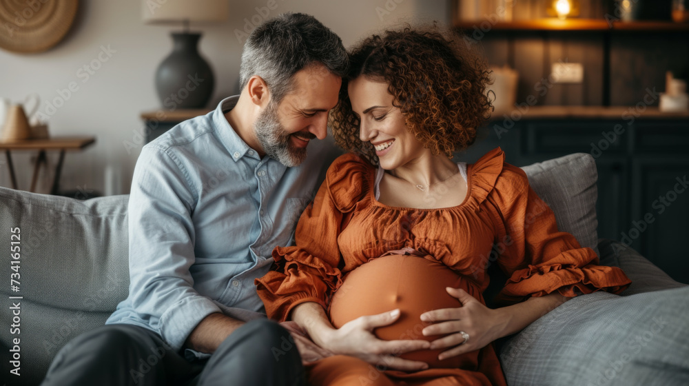 A couple shares a tender moment on a sofa, with the woman showing her ...