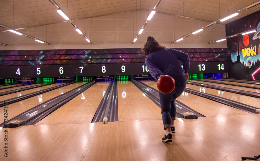 Rear shots of unrecognisable people ready to roll bowling alls at a ten ...
