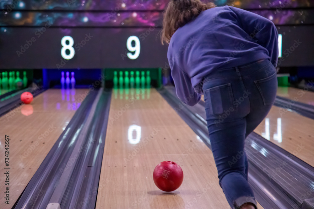 Rear shots of unrecognisable people ready to roll bowling alls at a ten ...