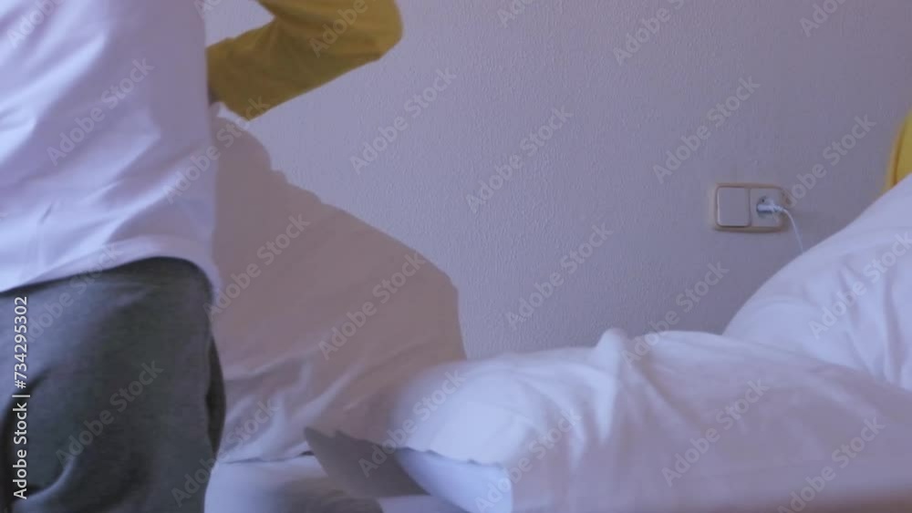 funny pillow fight in children's room, happy children, two healthy boys ...