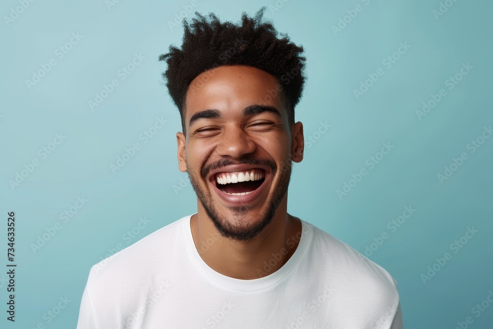 Attractive dark skinned man laughing heartily at internet meme ... Attractive dark skinned man laughing heartily at internet meme ...