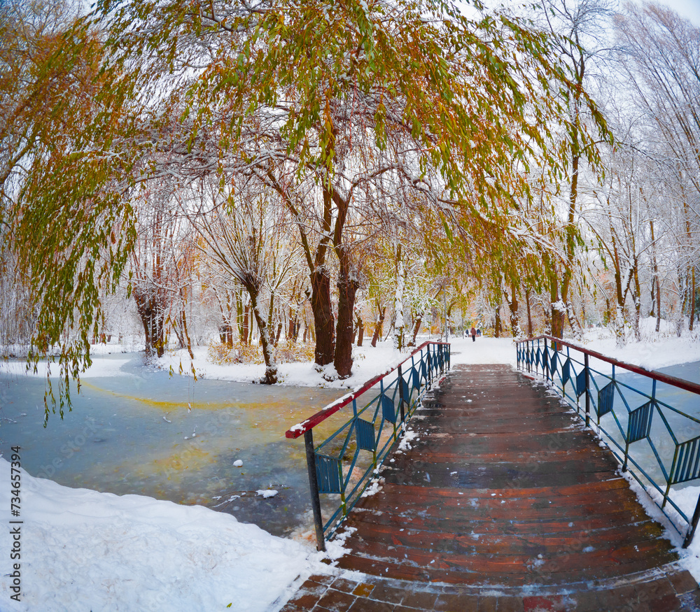 Cold winter scene of wooden pedestrian bridge on Seret river in ...