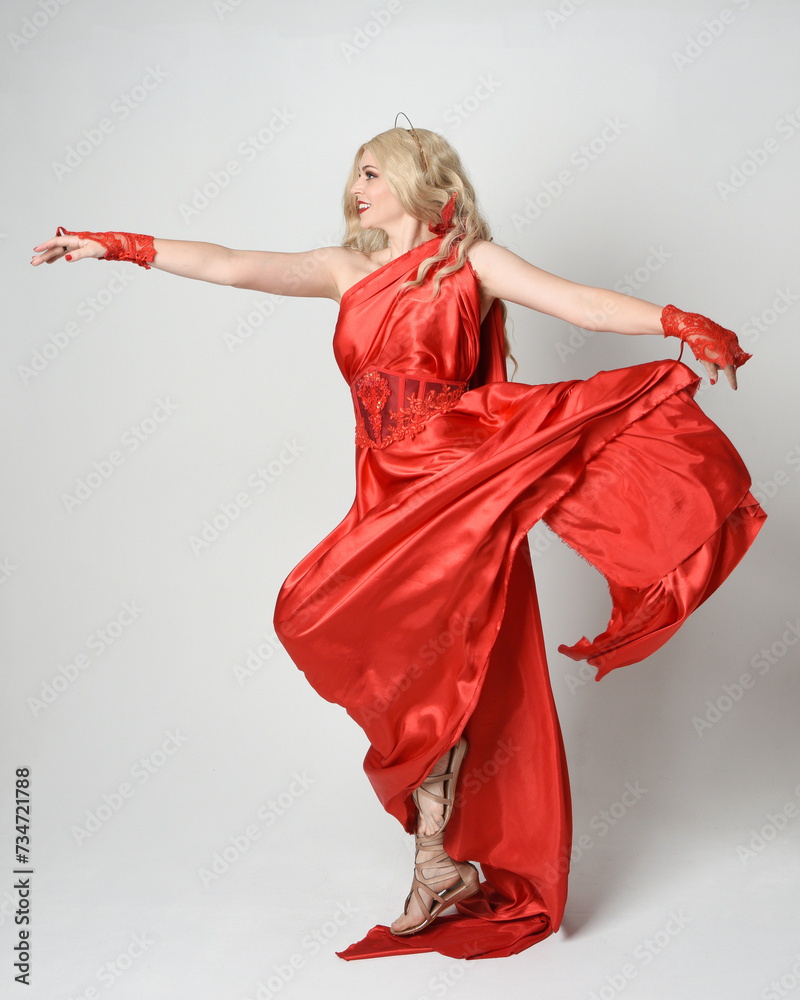 Full length portrait of blonde model dressed as ancient mythological ...