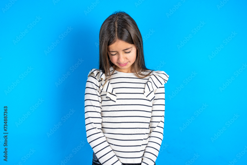 Dismal gloomy rejected Beautiful kid girl wearing striped T-shirt has ...