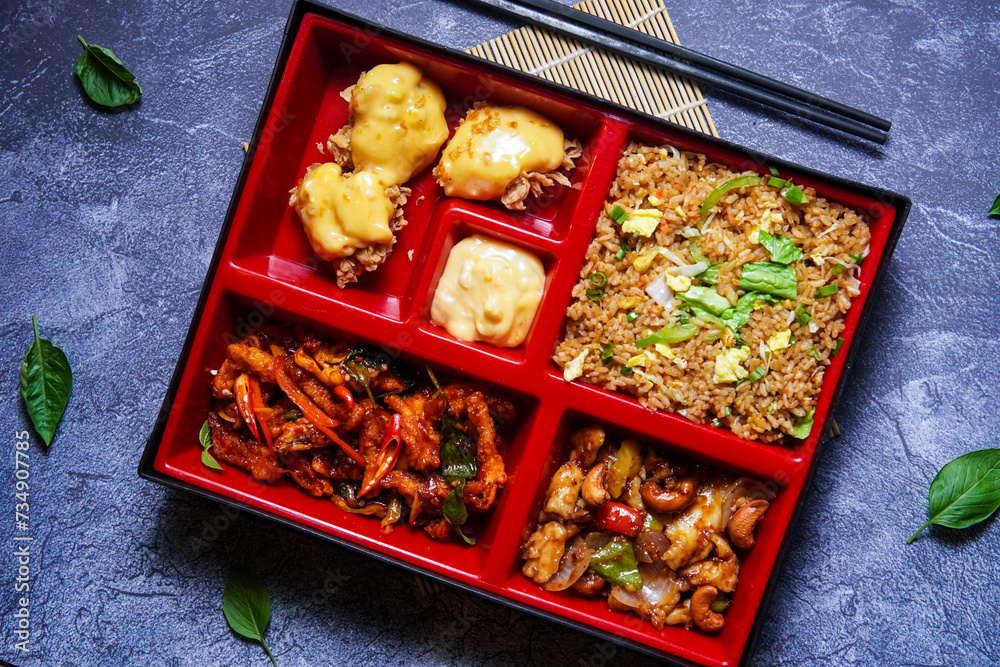Bento box on a grunge background with wasabi, soy sauce, and chopsticks ...