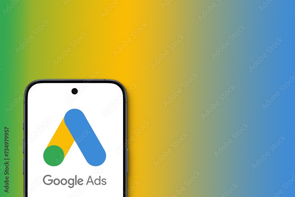Google Ads logo is displayed on a smartphone, behind a colorful ...