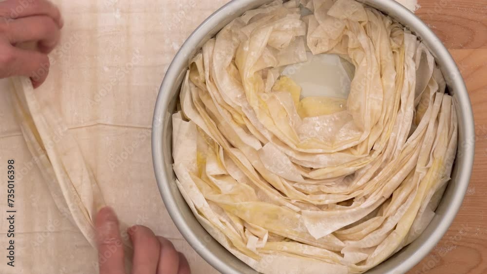 Phyllo dough pastry filled with cream cheese recipe. Woman hands roll ...