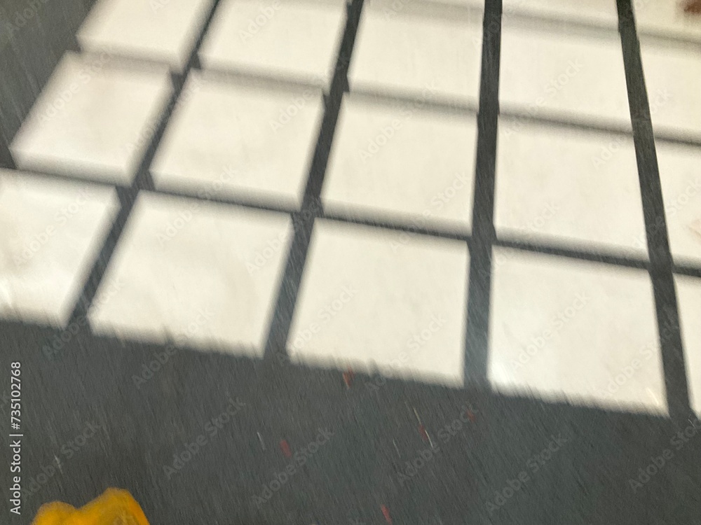 Poster Shadow of window grills on the concrete ground , window grills ...