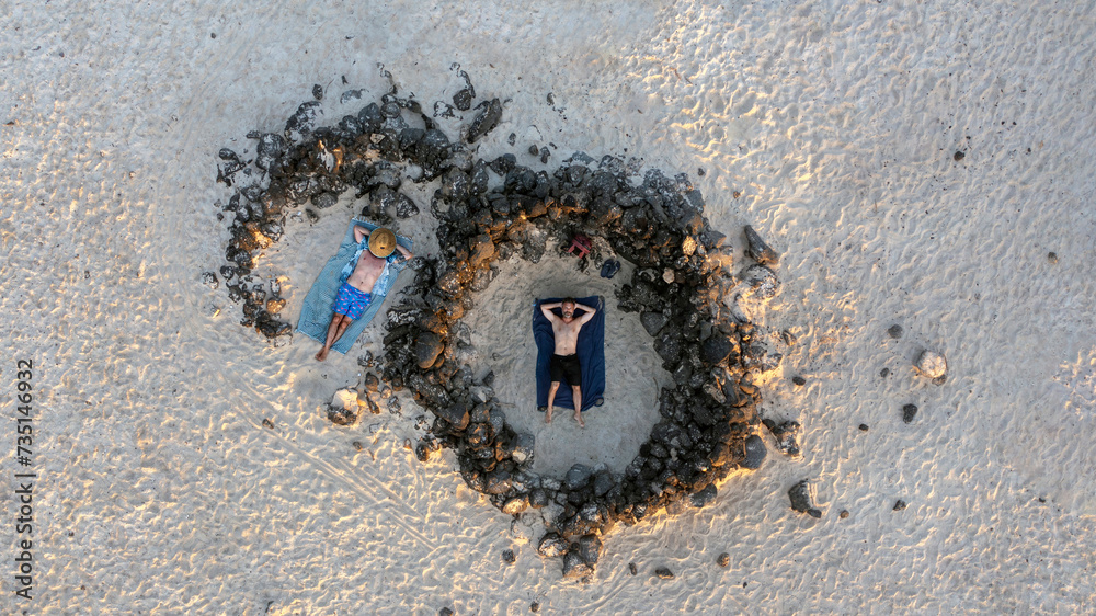 Aerial view from flying drone of two friend crowd relaxing on the beach ...