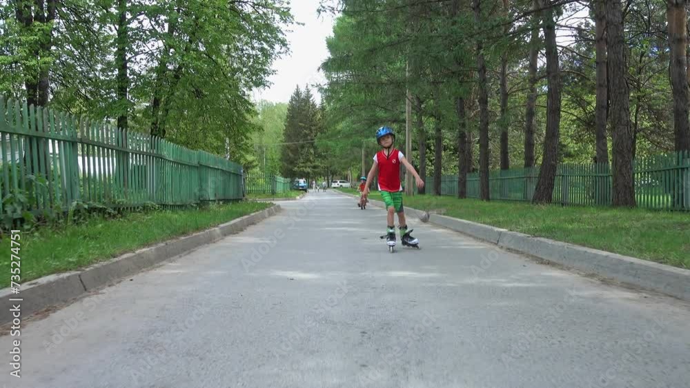 Kids biking and rollerblading. Boy riding on roller skates at outdoor ...