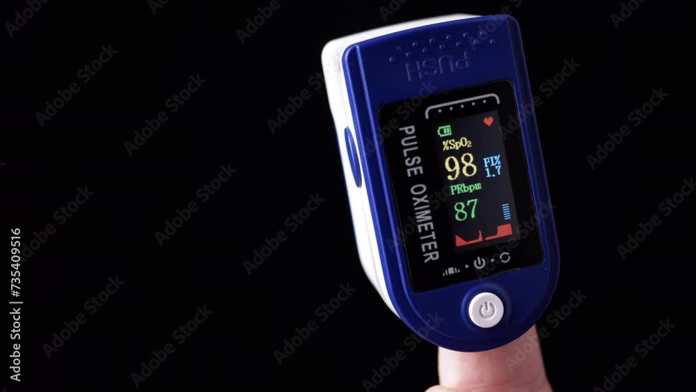 Woman Measures Pulse and Oxygen Saturation Using a Pulse Oximeter at ...