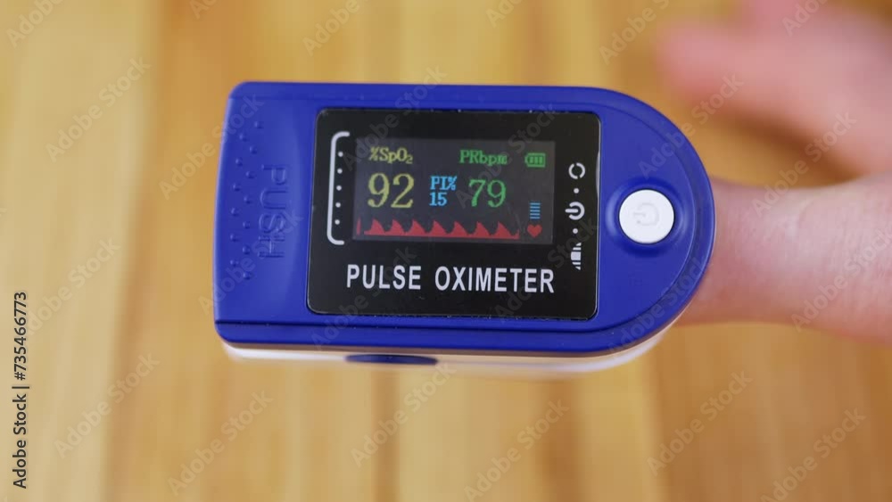 Woman Measures Pulse and Oxygen Saturation Using a Pulse Oximeter at ...