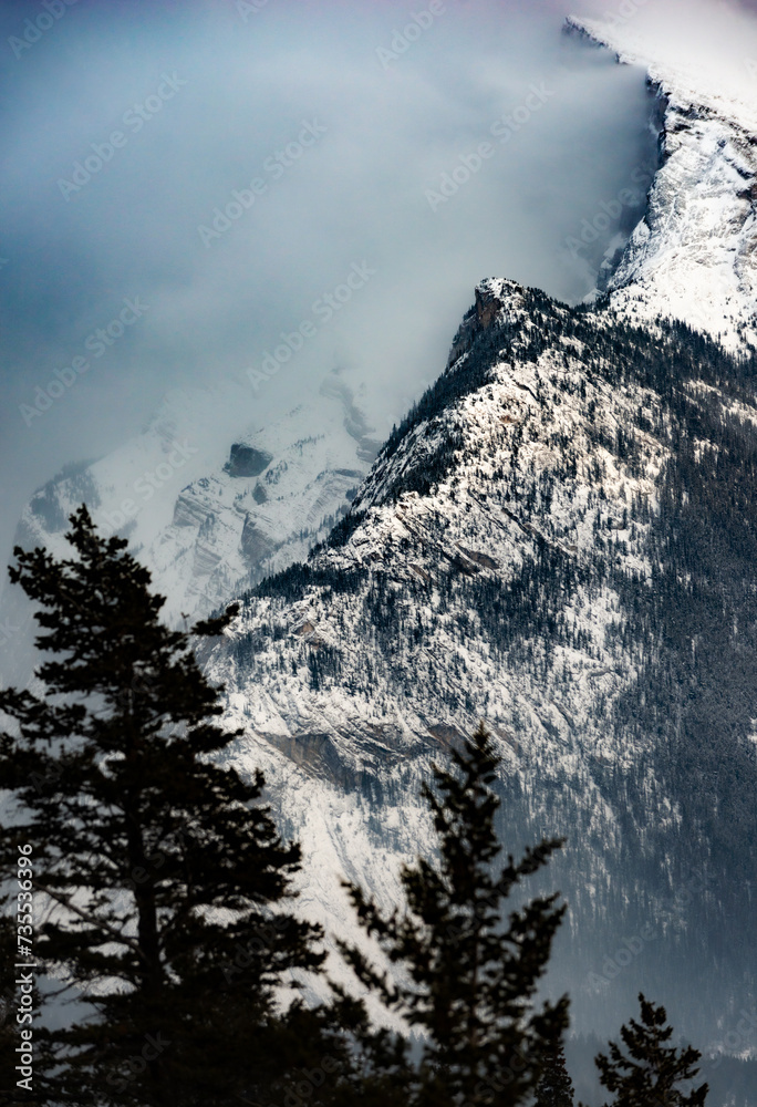 Winter Landscape Mount Rundle rises majestically, its crest covered in ...
