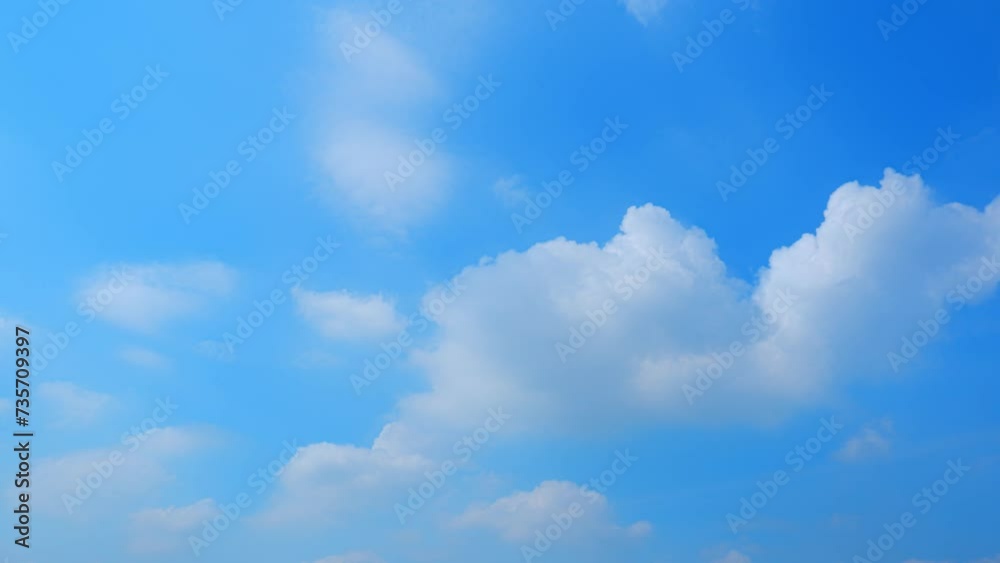 4K : Blue sky time lapse - Gently shifting clouds dance across a serene ...