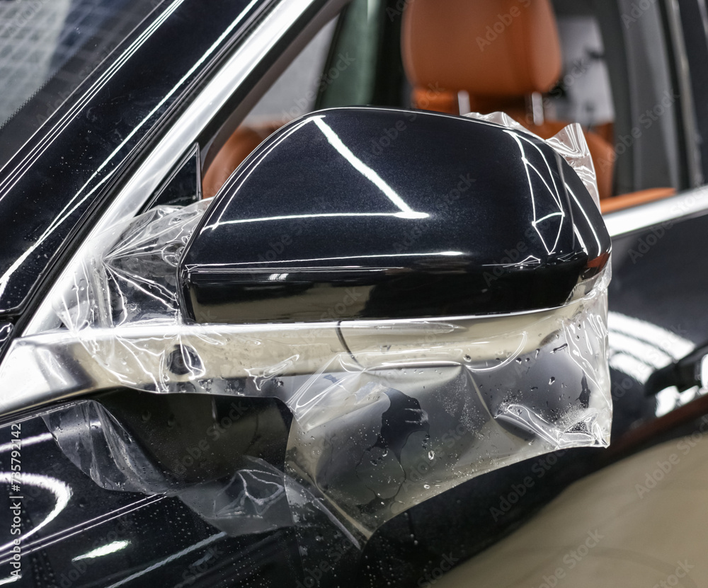 The process of installing PPF on the side mirror. PPF is a protective ...